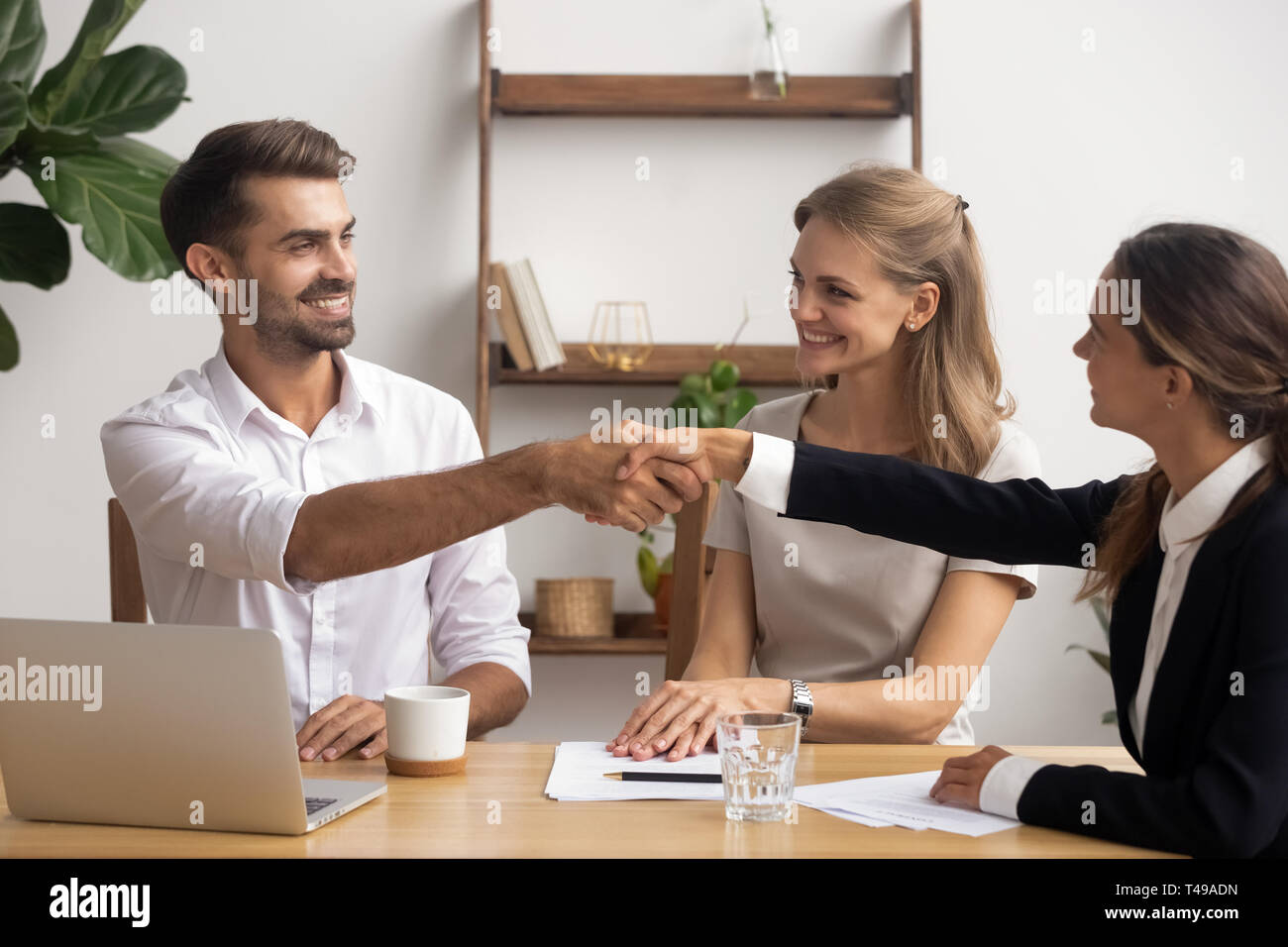 Happy employees handshake at corporate meeting welcoming new team ...