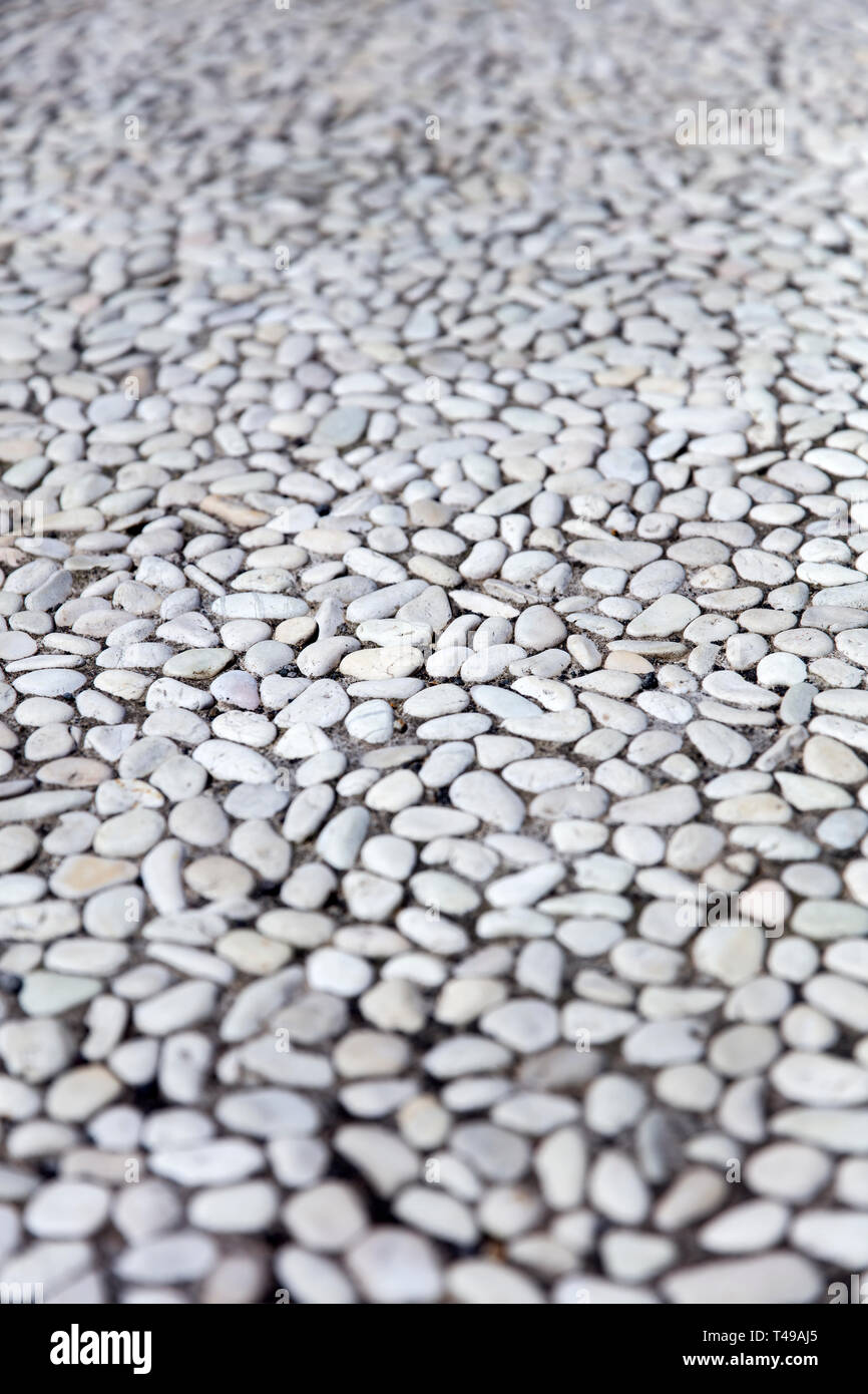 Backdrop of small round stones in the concrete wall Stock Photo - Alamy