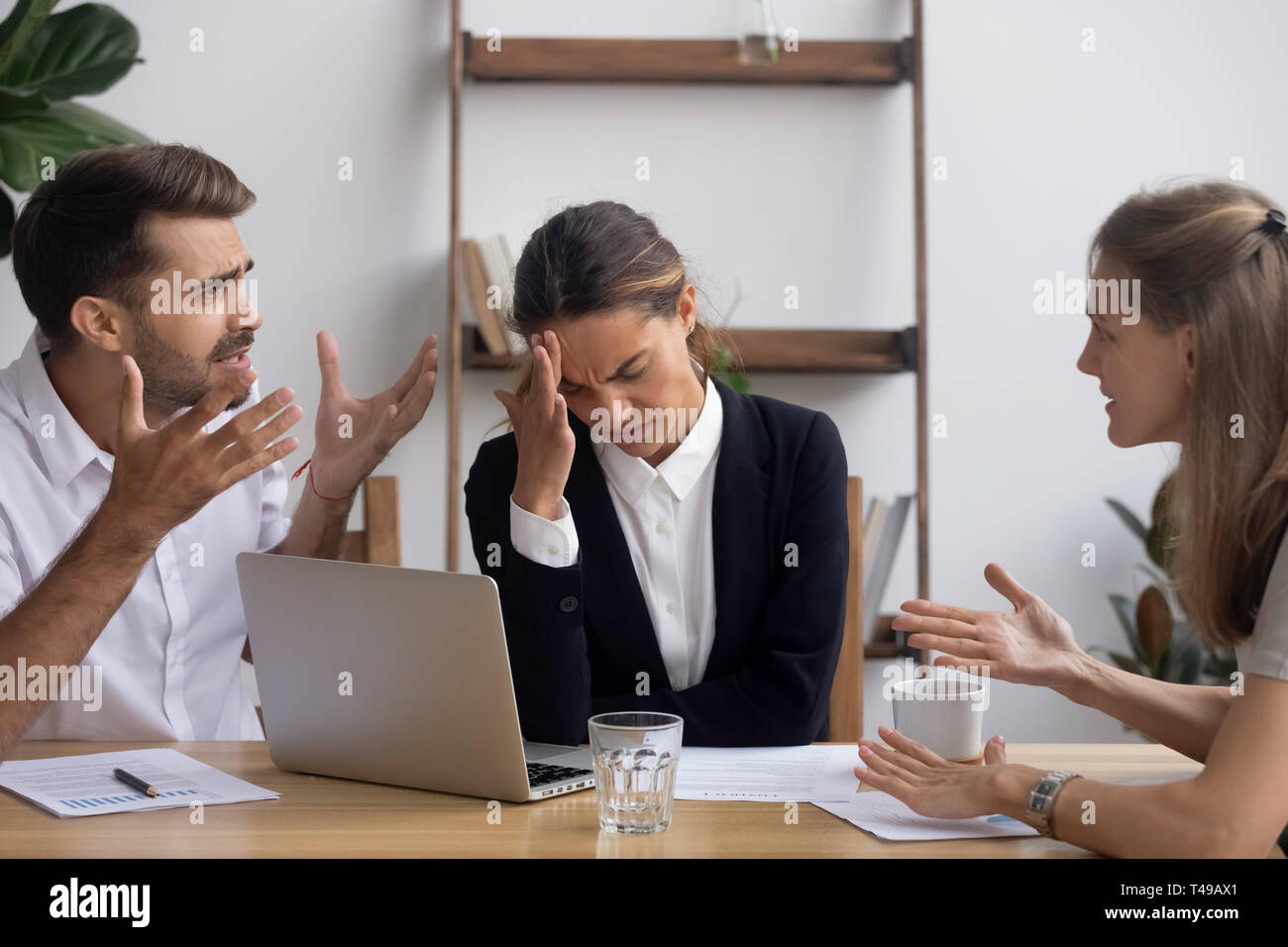 Stressed annoyed office employee having headache migraine at business meeting Stock Photo - Alamy