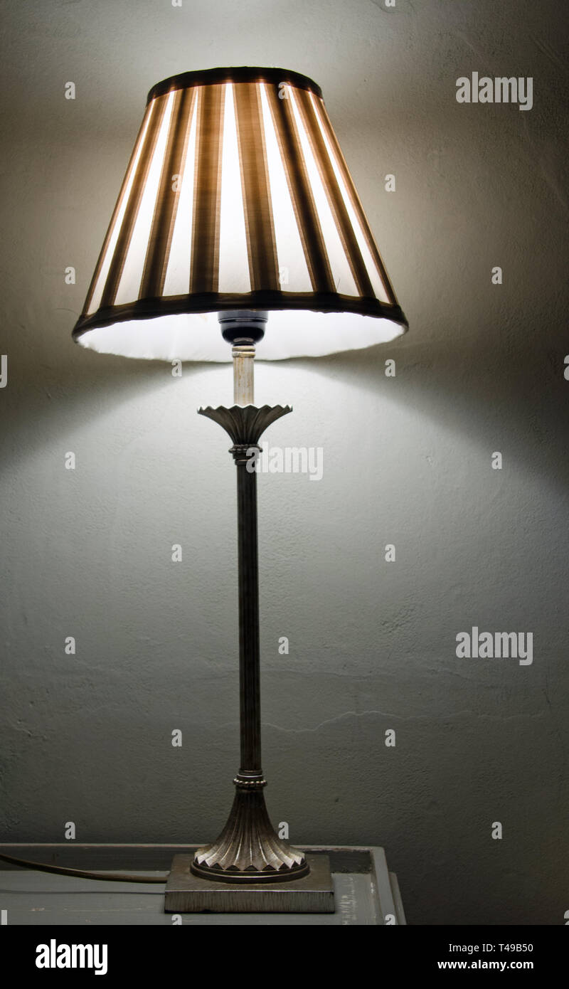 Decorative vintage lamp on top of a table with the light on Stock Photo ...