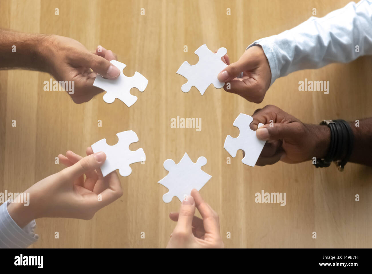 Person connecting puzzle pieces hi-res stock photography and images - Alamy