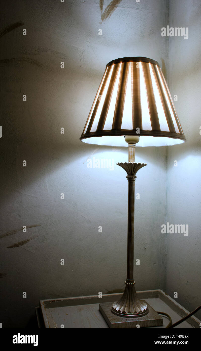 Decorative vintage lamp on top of a table with the light on Stock Photo ...