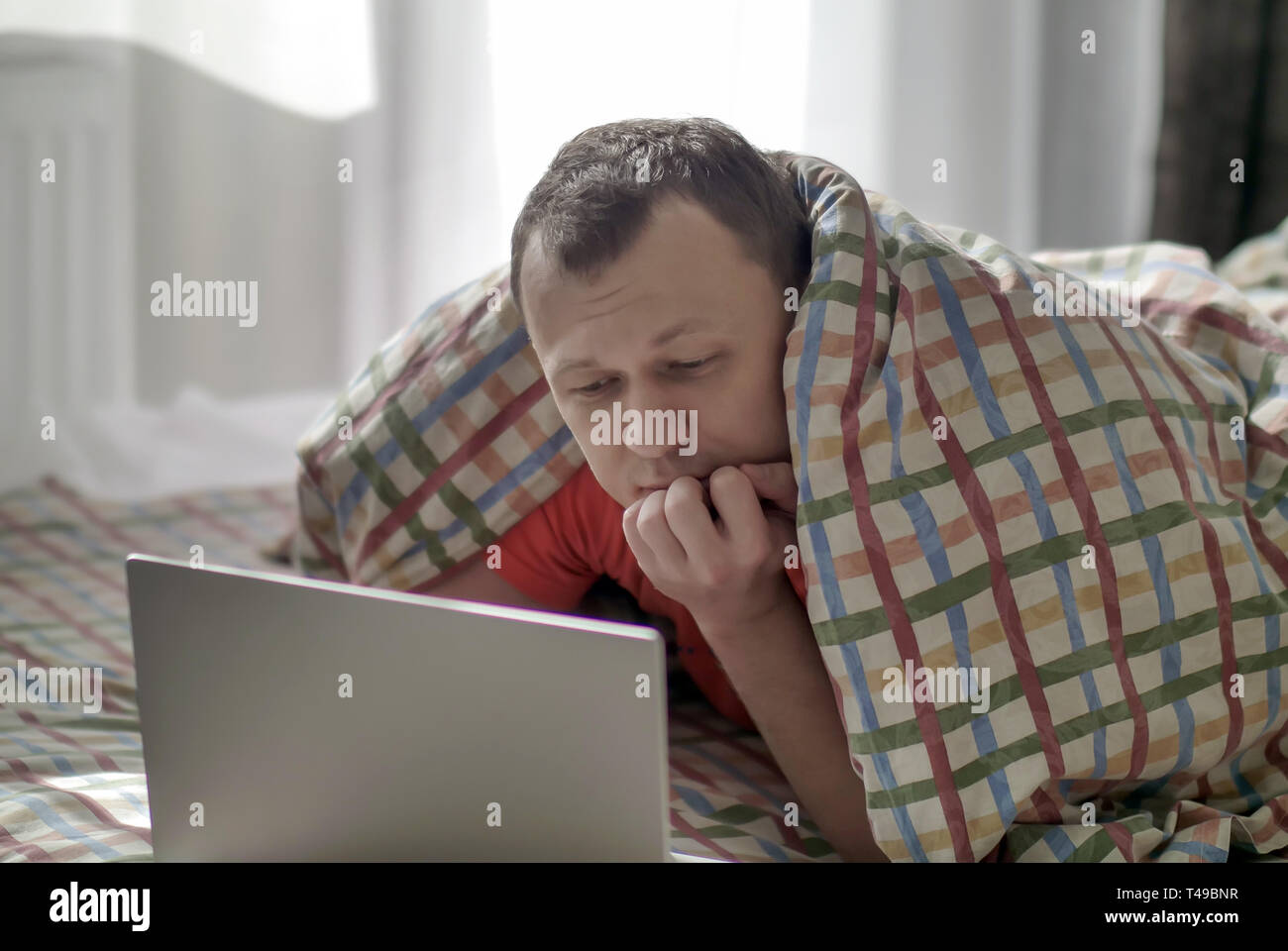 Man looking under covers bed hi-res stock photography and images - Alamy