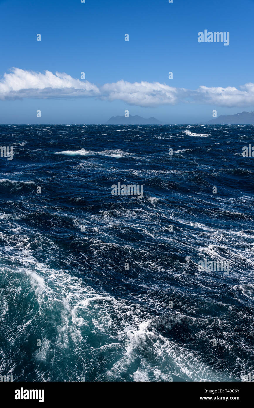 View of Atlantic Ocean and distant mountains, choppy water, calm blue ...