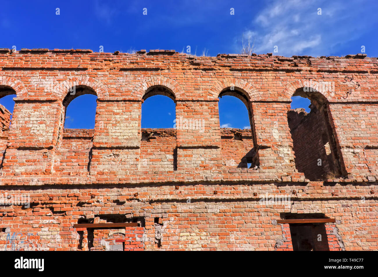 The ruins of an old brick building of red brick. The chimneys of the ...