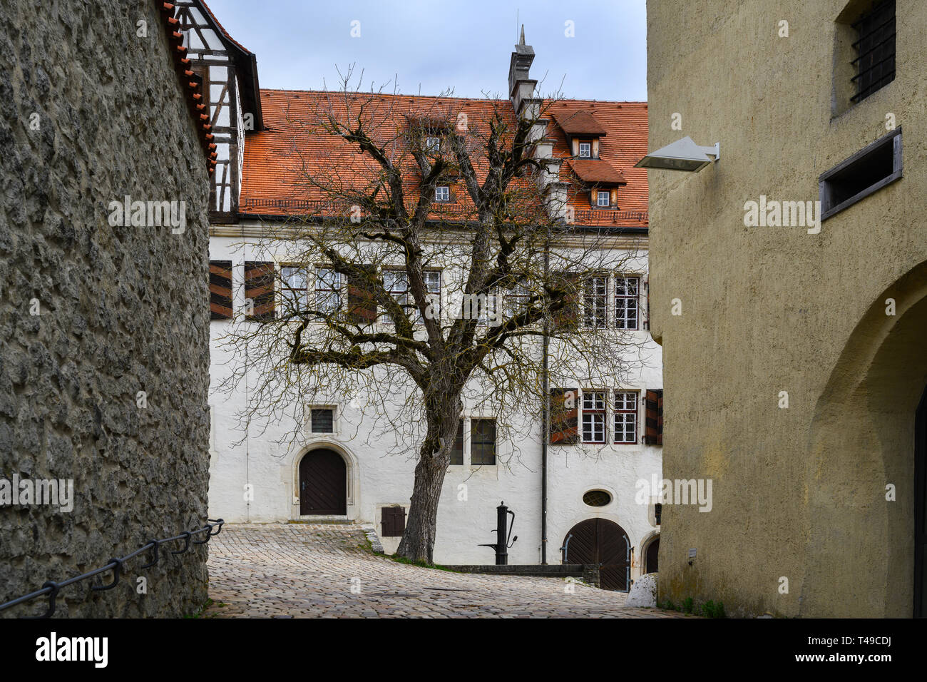 courtyard with bare tree and fountain the castle Hellenstein on the ...