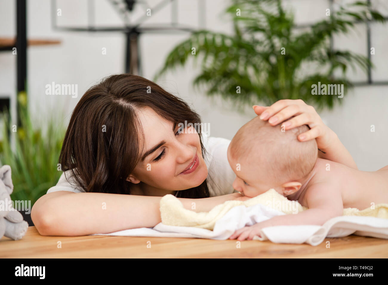 Mother smile caress touch baby girl head Stock Photo - Alamy