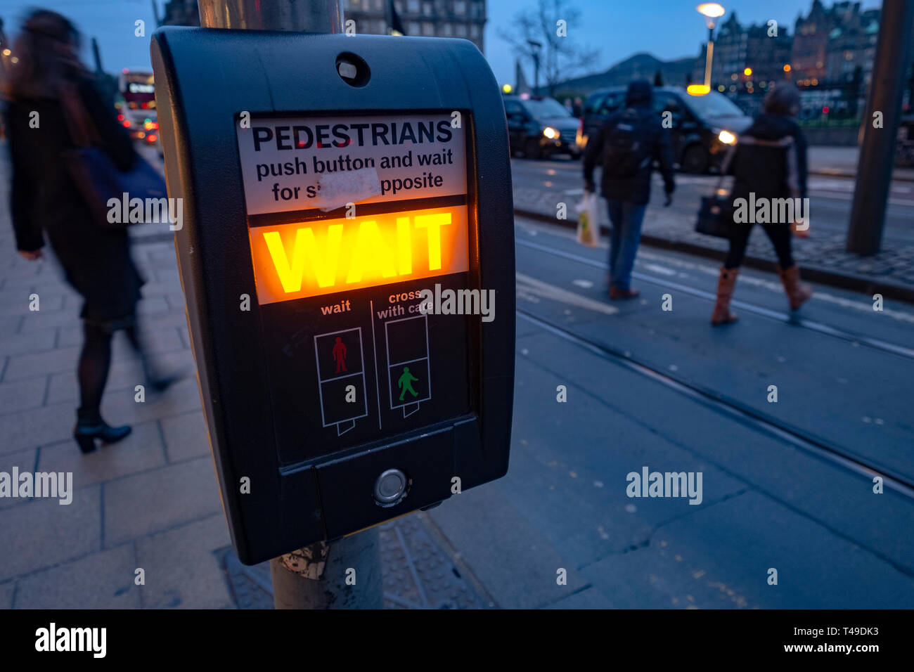 Pedestrians crossing the street despite red lights and orders to wait ...