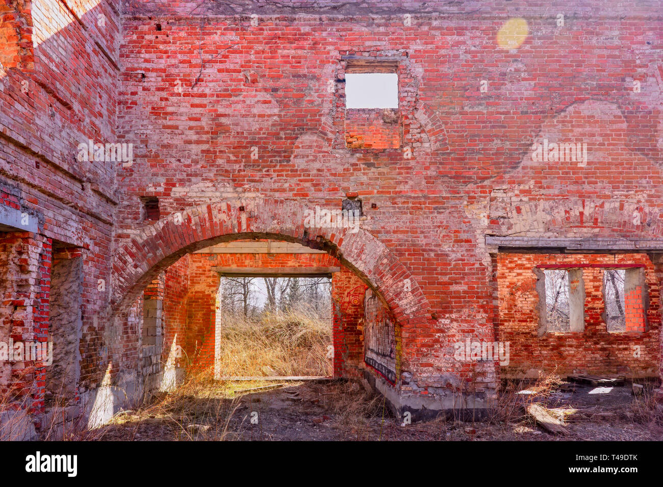 The ruins of an old brick building of red brick. The chimneys of the ...