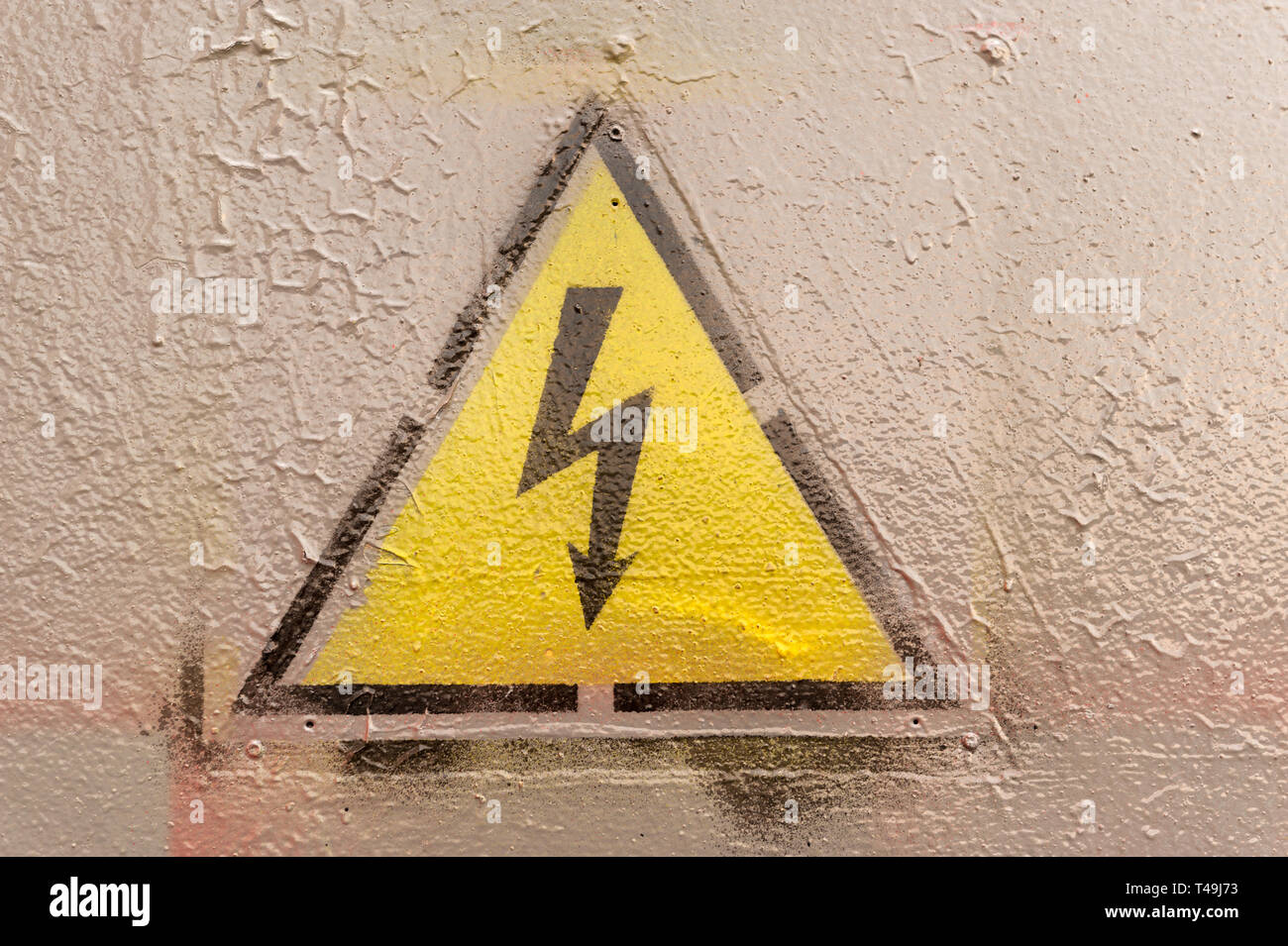 high voltage yellow sign on the painted wall Stock Photo - Alamy