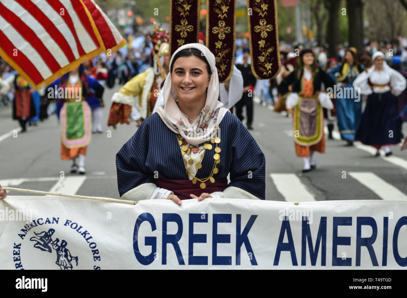 A Greek woman seen holding a banner while smiling during the annual ...