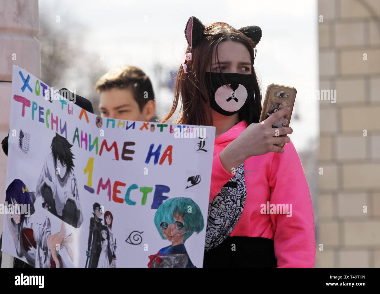 A youth dressed in costume of anime character is seen taking a picture ...