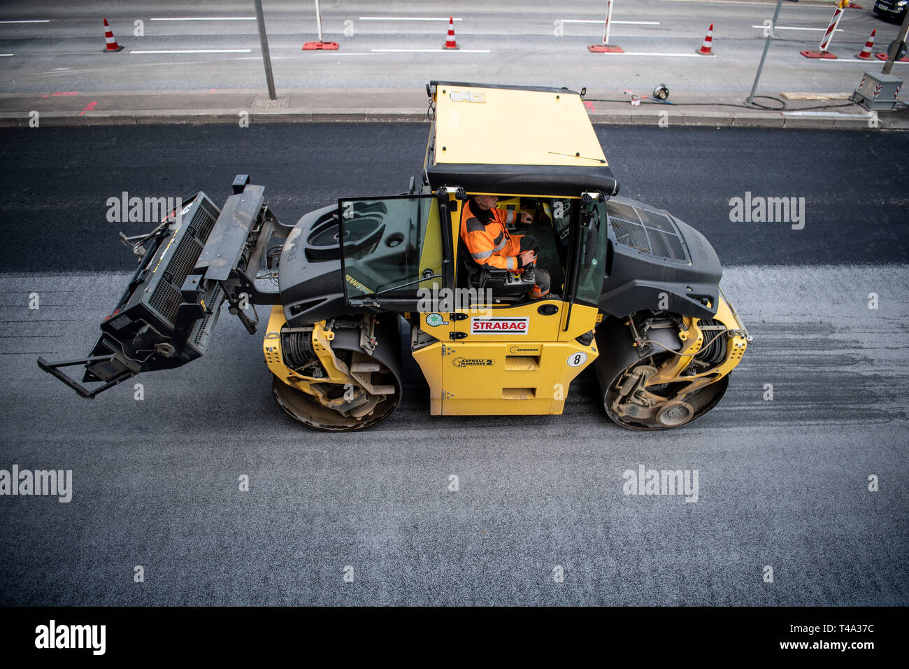 Stuttgart, Germany. 15th Apr, 2019. A steam roller travels over the ...