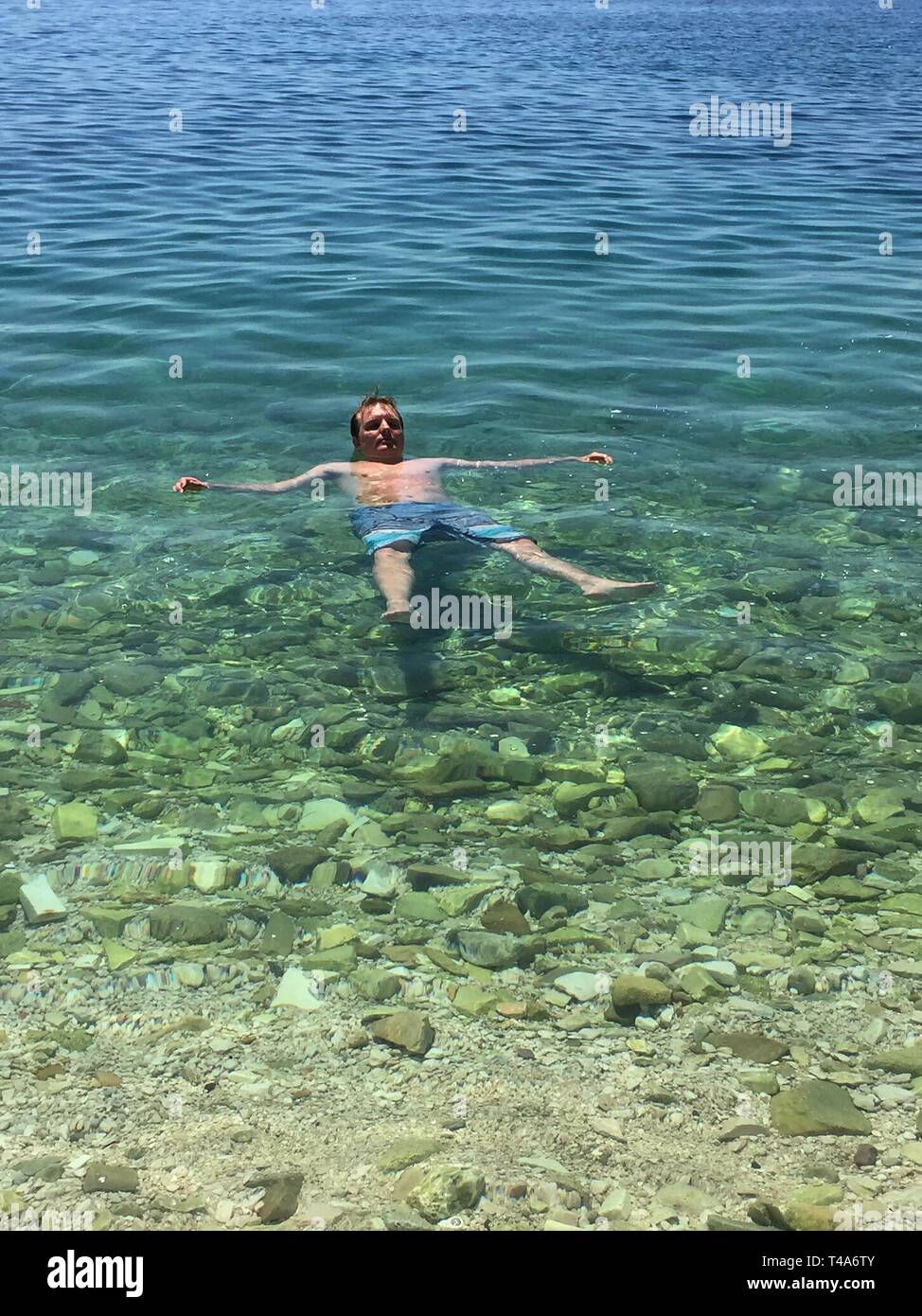 Handsome man floating in pool hi-res stock photography and images - Alamy