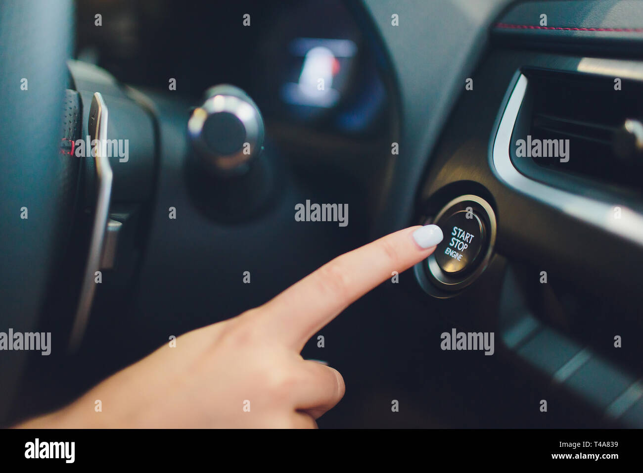 Car driver starting the engine keyless. Black. female hand Stock Photo ...