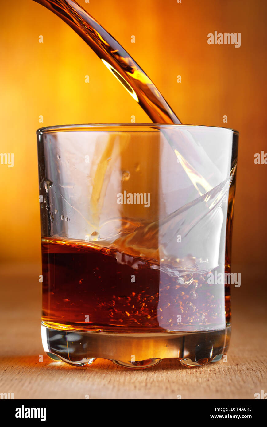 whiskey being poured into a glass Stock Photo - Alamy