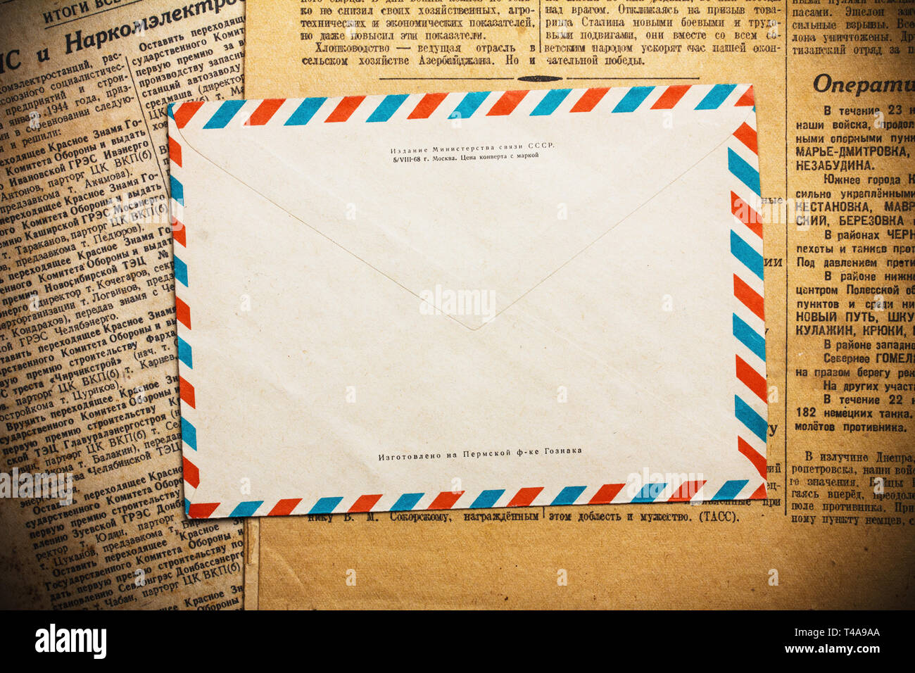 Envelope on aged newspaper Stock Photo - Alamy