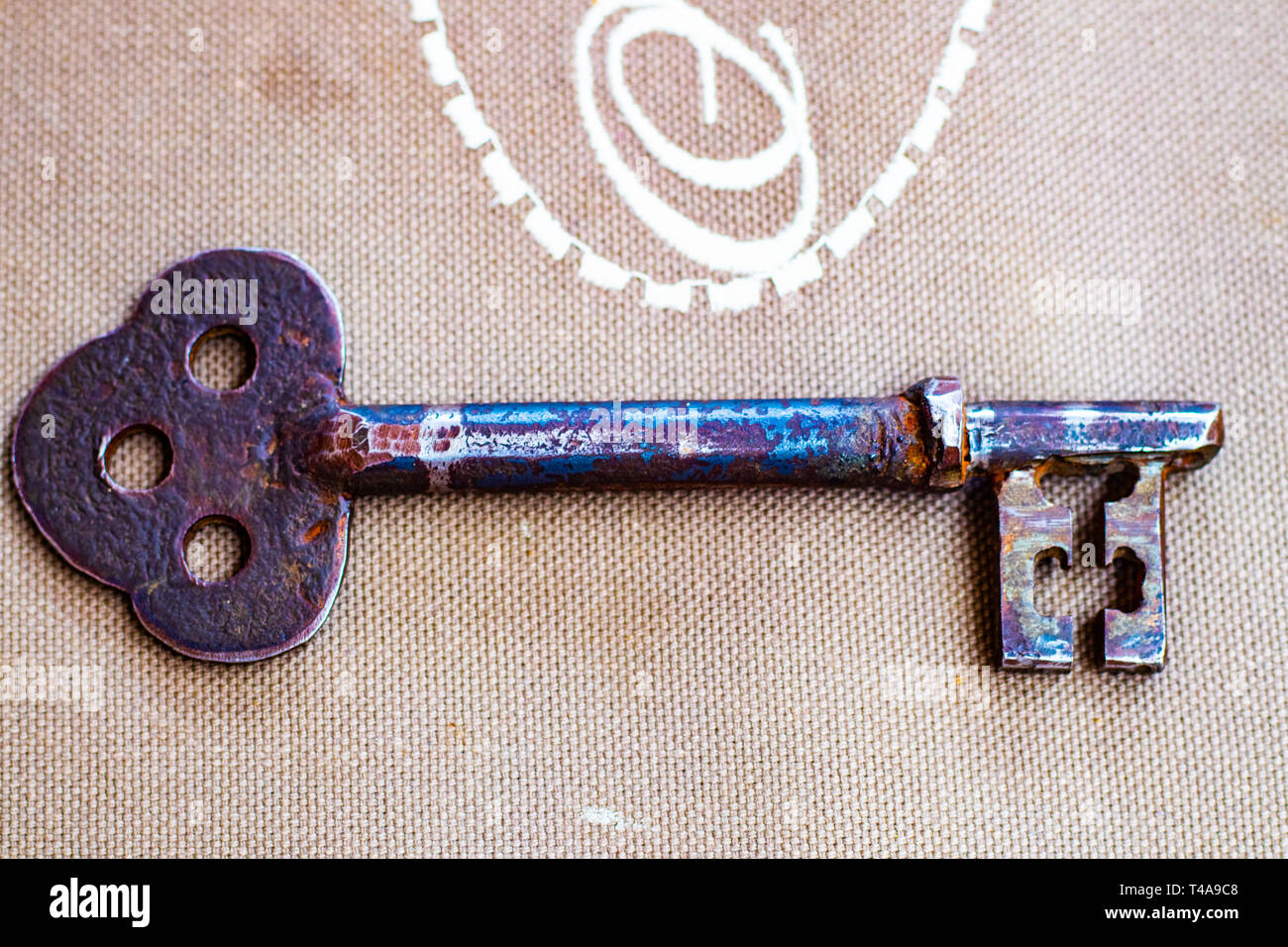 An Ancient Key on fancy modern fabric Stock Photo - Alamy
