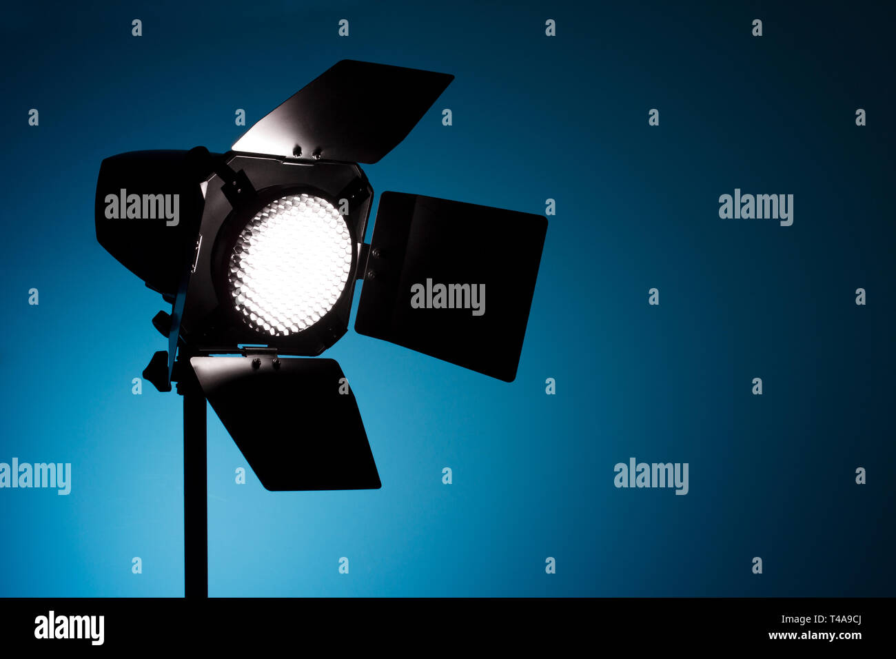 Studio spot light on blue background Stock Photo - Alamy