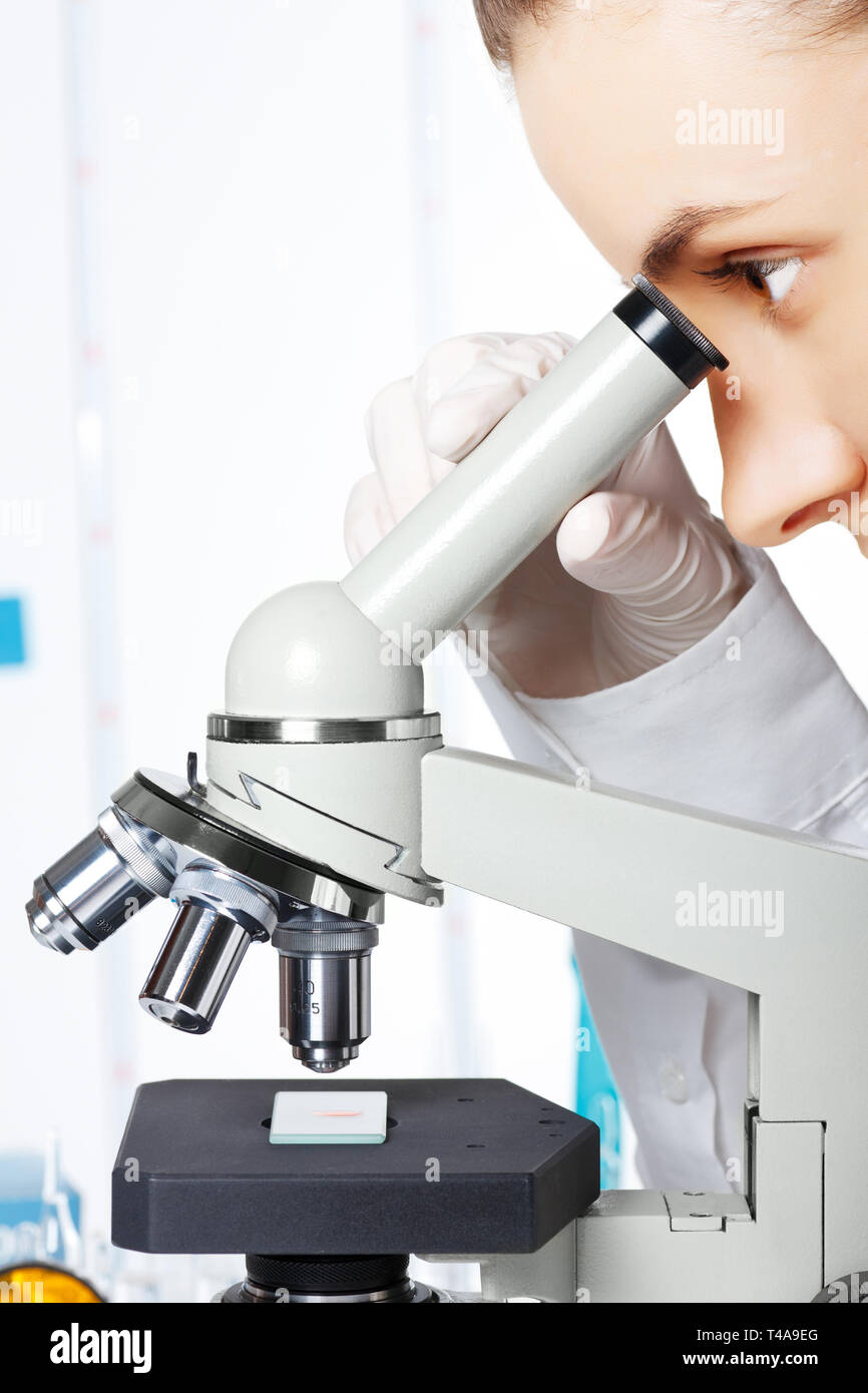 Closeup woman looking through microscope hi-res stock photography and ...