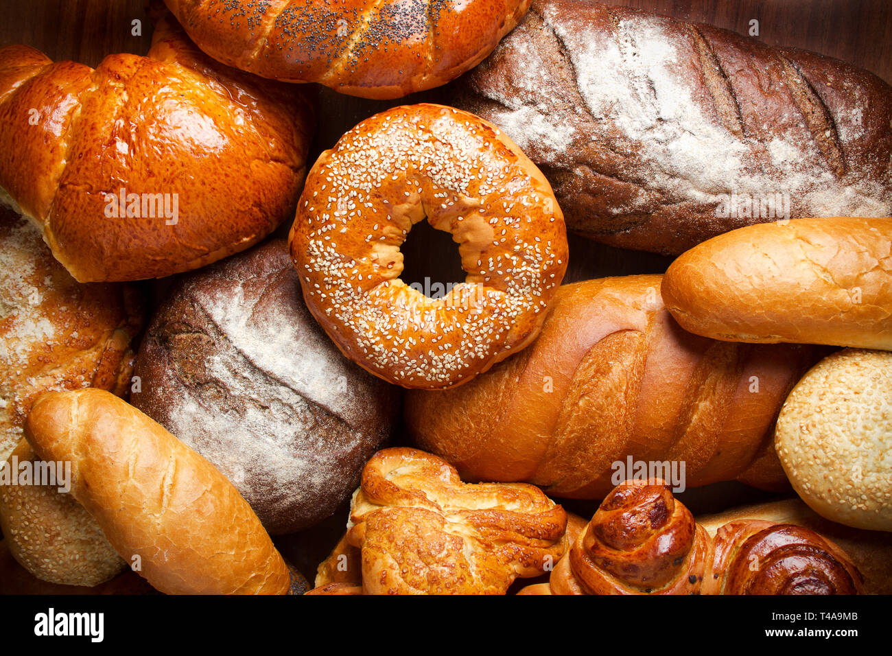 Bread assortment on wooden table background Stock Photo - Alamy