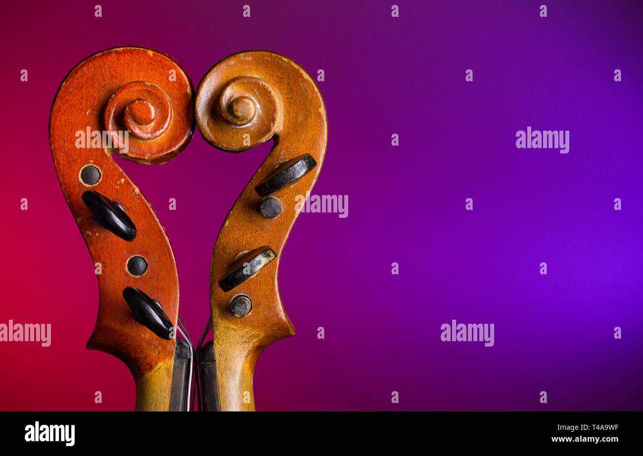 Two vintage violin scrolls make heart shape with copy-space Stock Photo ...