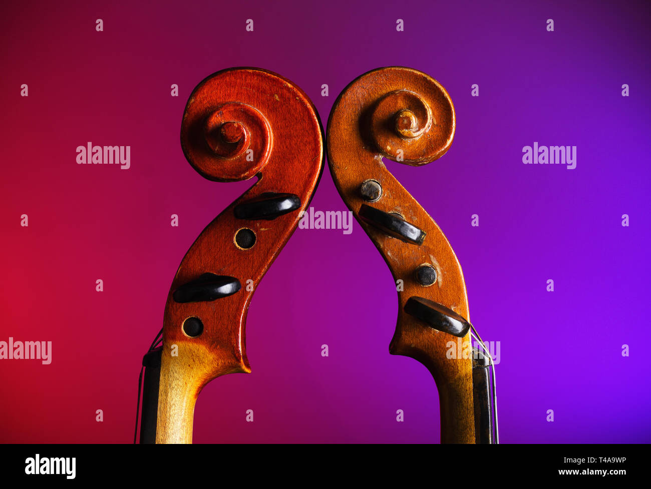 Two vintage violin scrolls Stock Photo - Alamy