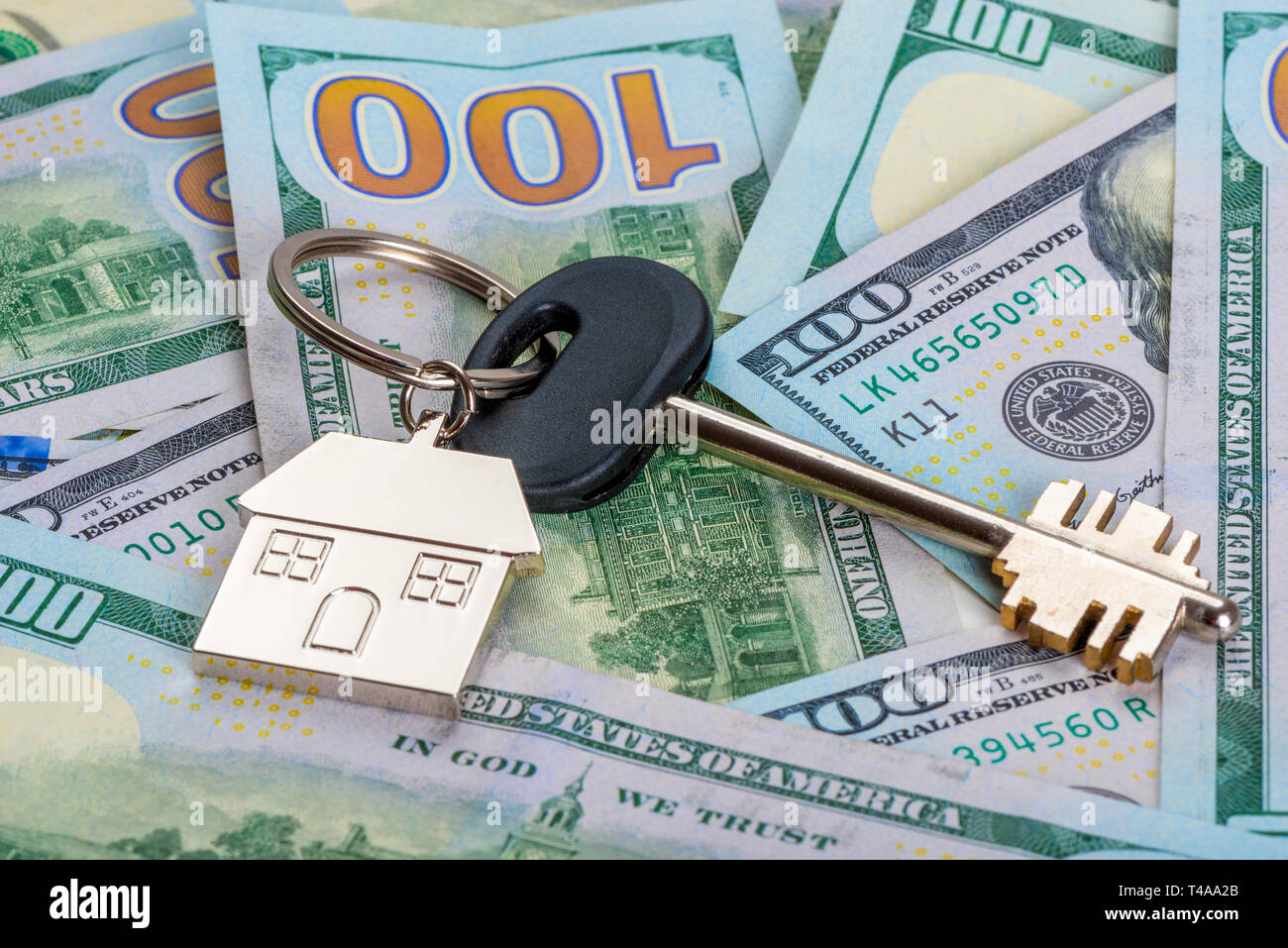 concept photo of money and real estate a key from a new house on a pile ...