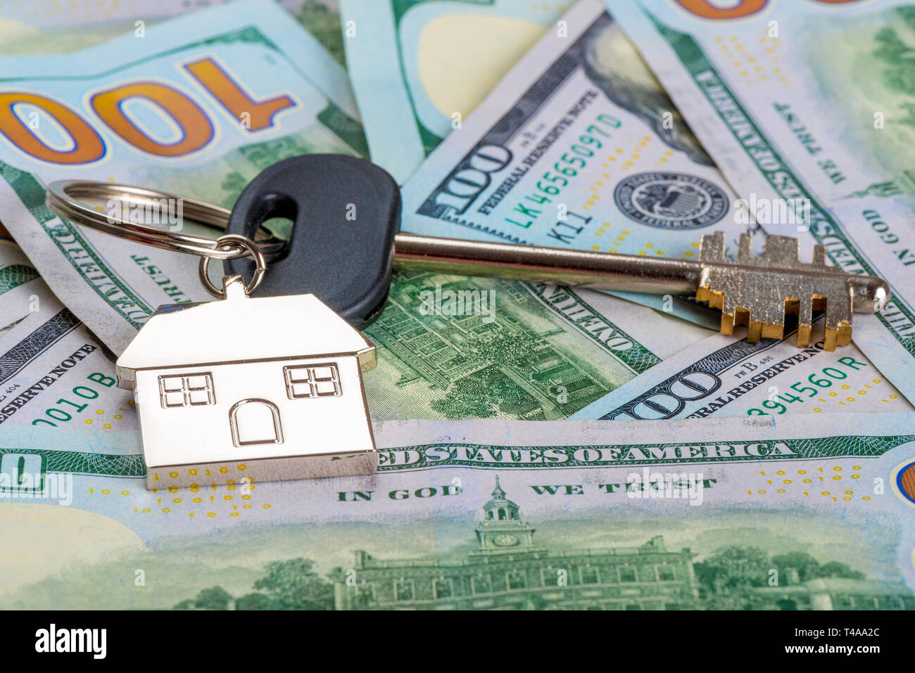new house key on pile of american dollars close up Stock Photo - Alamy