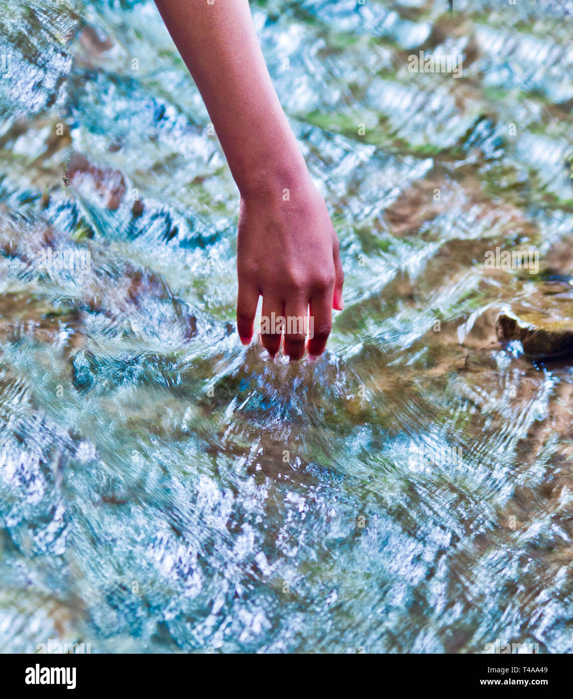 water, source of life, and hand of a young boy Stock Photo - Alamy