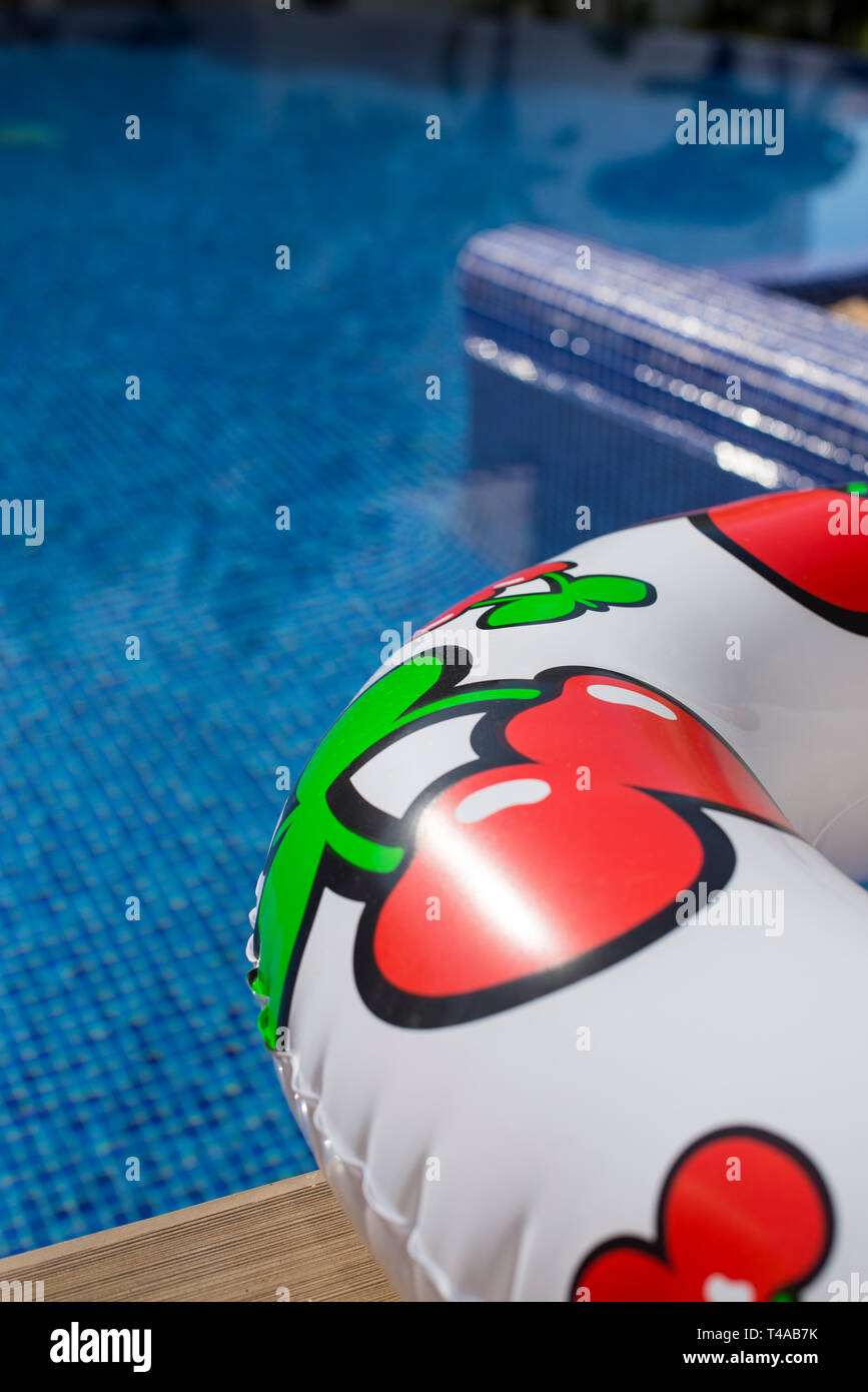 Inflatable rubber ring with Pacha cherry logo by swimming pool Stock ...