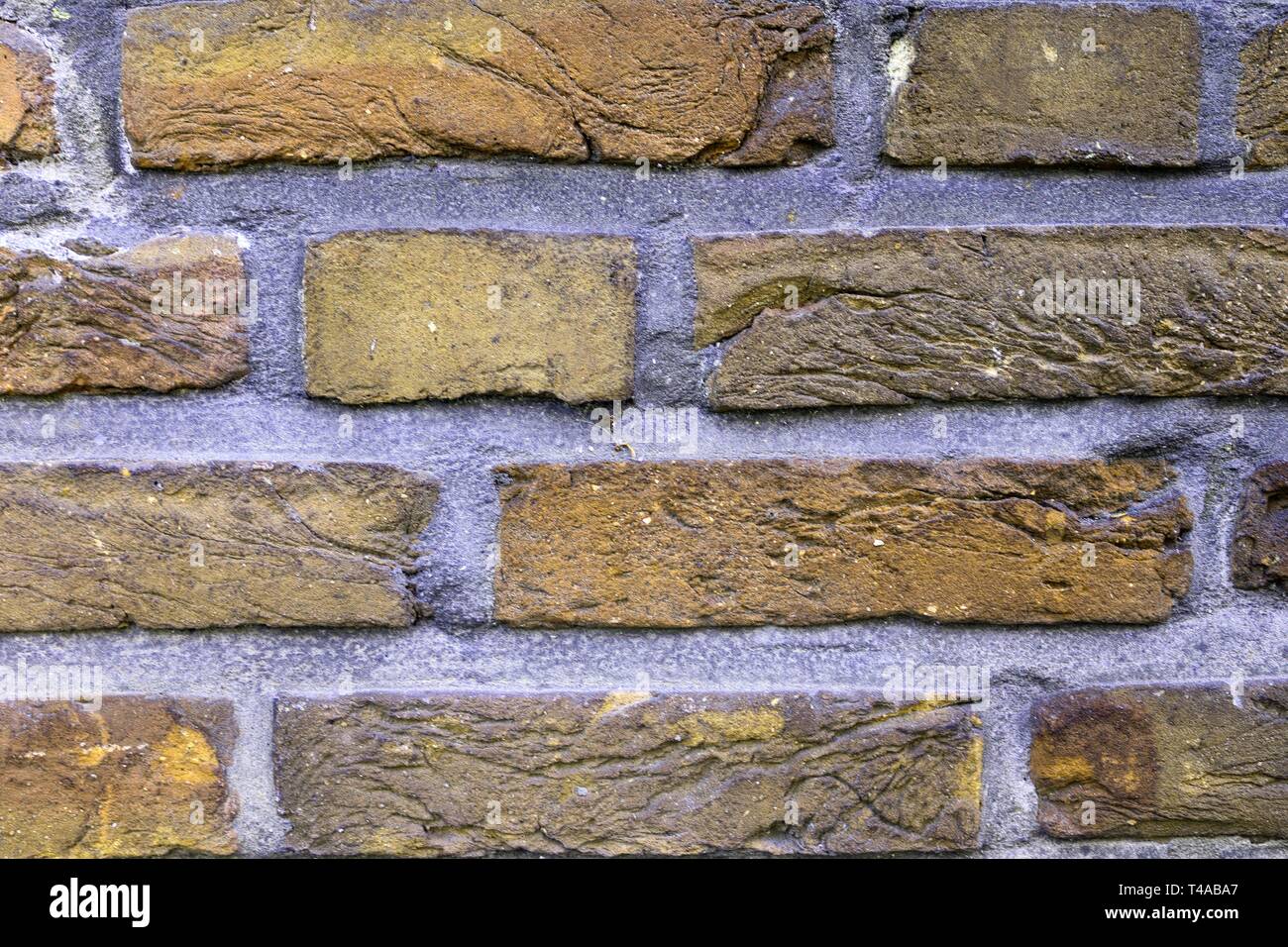 Weathered and aged yellow brick walls with cracks in high resolution ...