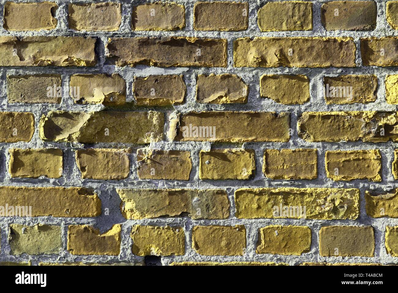 Weathered and aged yellow brick walls with cracks in high resolution ...