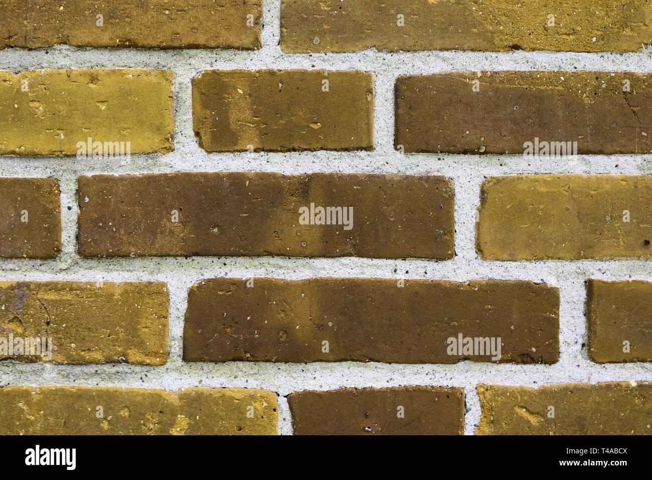 Weathered and aged yellow brick walls with cracks in high resolution ...