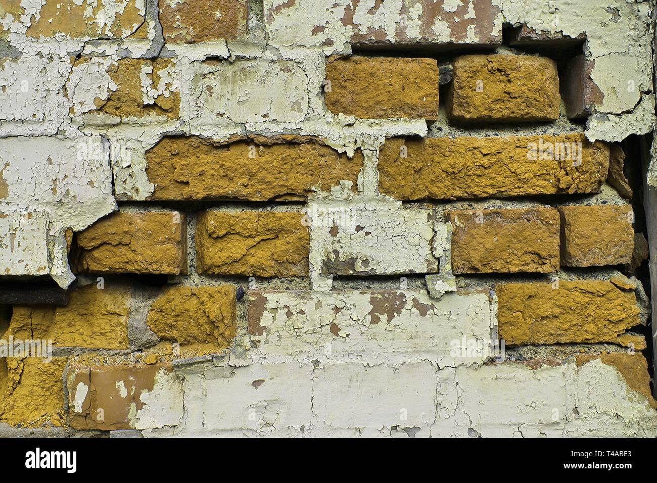 Weathered and aged yellow brick walls with cracks in high resolution ...