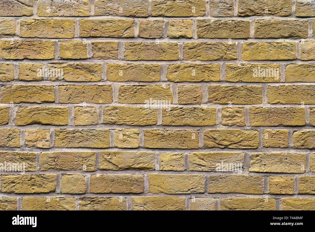 Weathered and aged yellow brick walls with cracks in high resolution ...