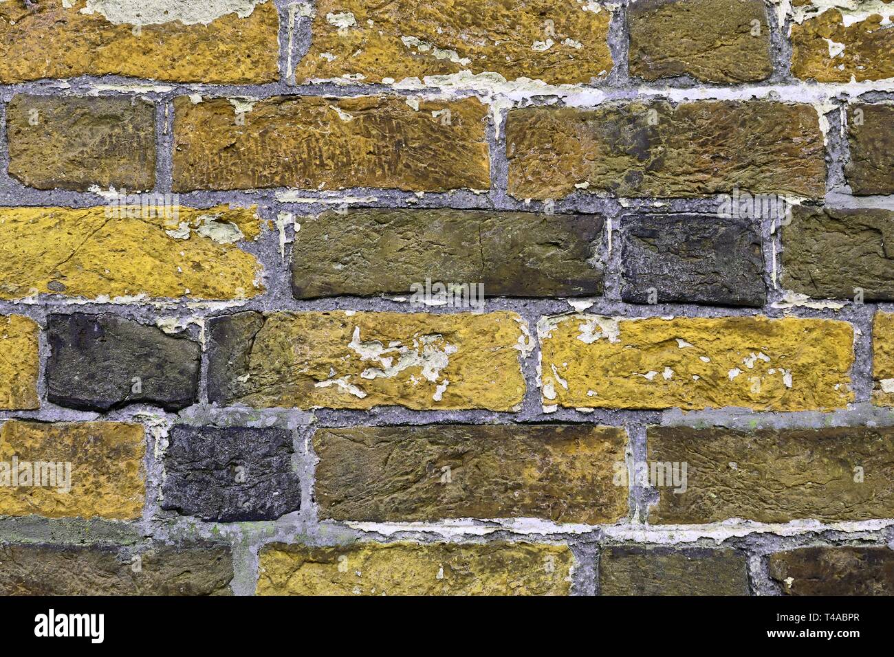 Weathered and aged yellow brick walls with cracks in high resolution ...