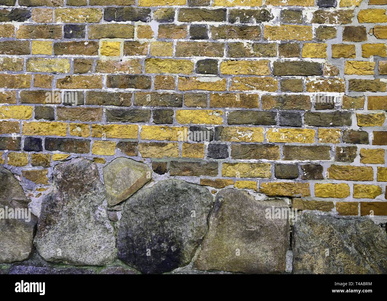 Weathered and aged yellow brick walls with cracks in high resolution ...