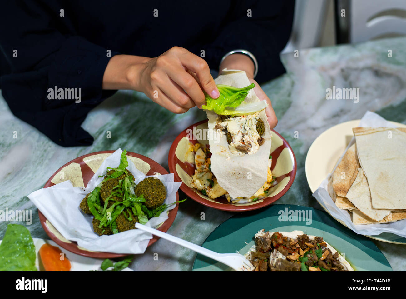 Woman having Arabic food in a restaurant close up Stock Photo - Alamy