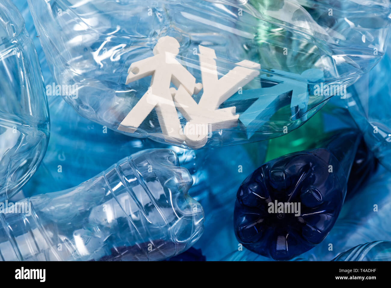 Colorful figures of people placed inside of plastic bottle Stock Photo ...