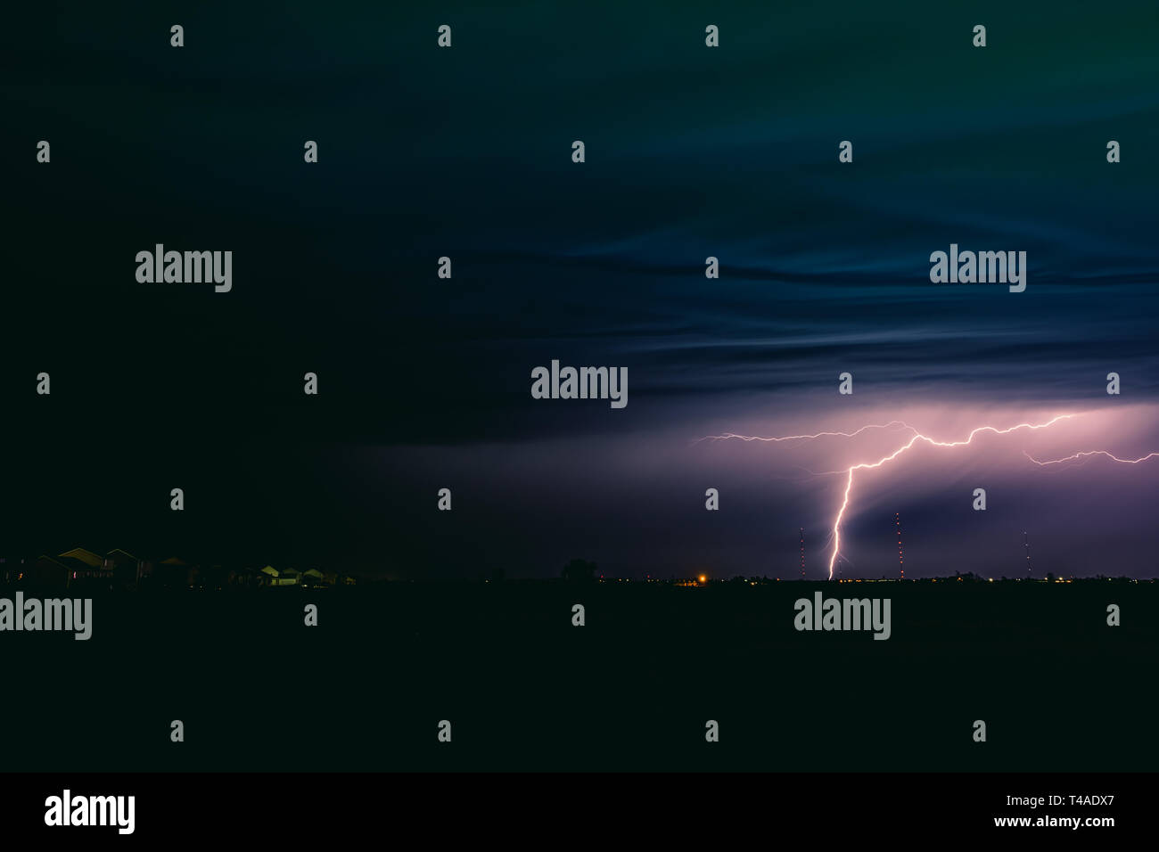 View of lightning strike over a rural farm field, lightning strikes the ...