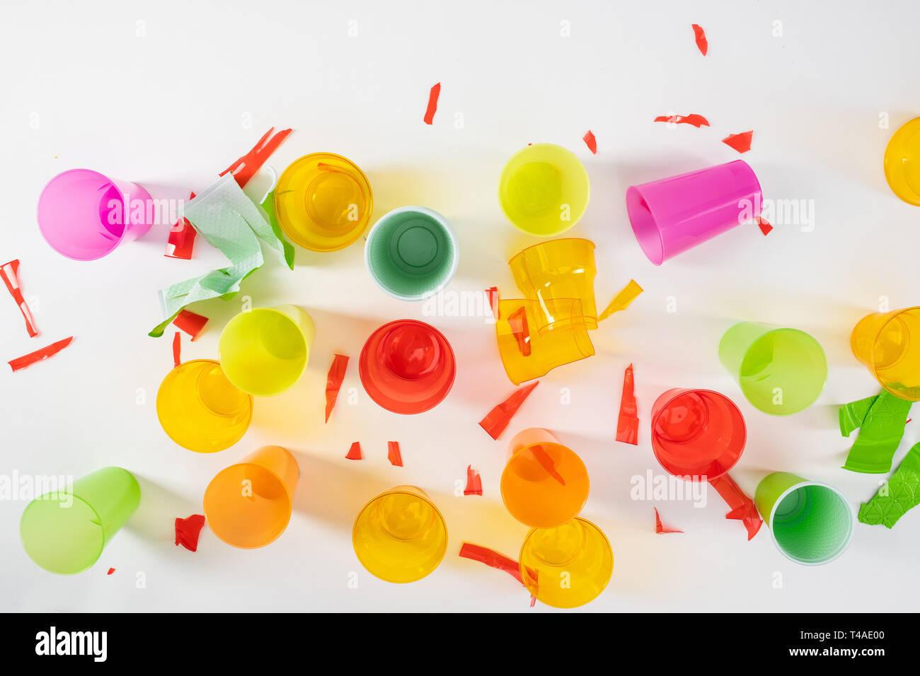Sharp broken pieces of plastic cups lying on white surface Stock Photo ...