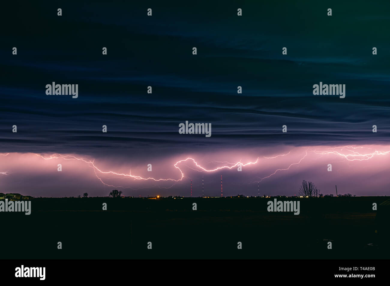 View of lightning strike over a rural farm field, lightning strikes the ...