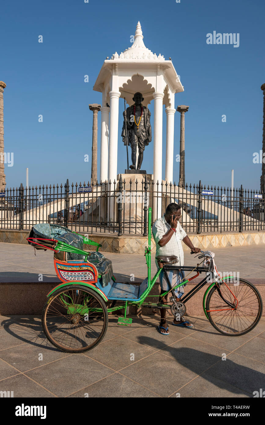Vertical view of a cycle rickshaw infront of the Gandhi memorial in ...