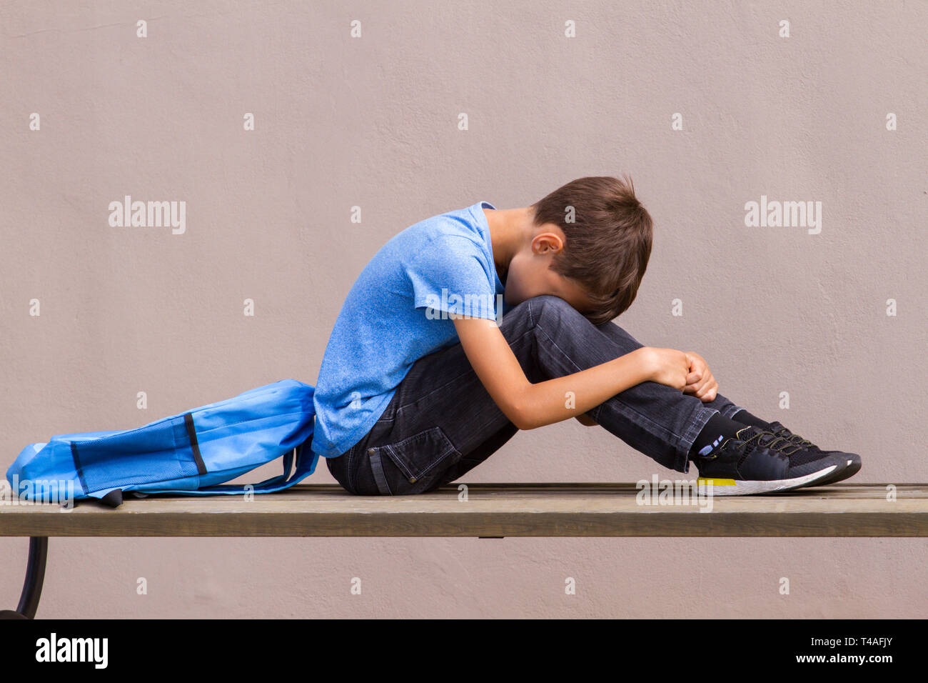 Boy sitting head down sad hi-res stock photography and images - Alamy