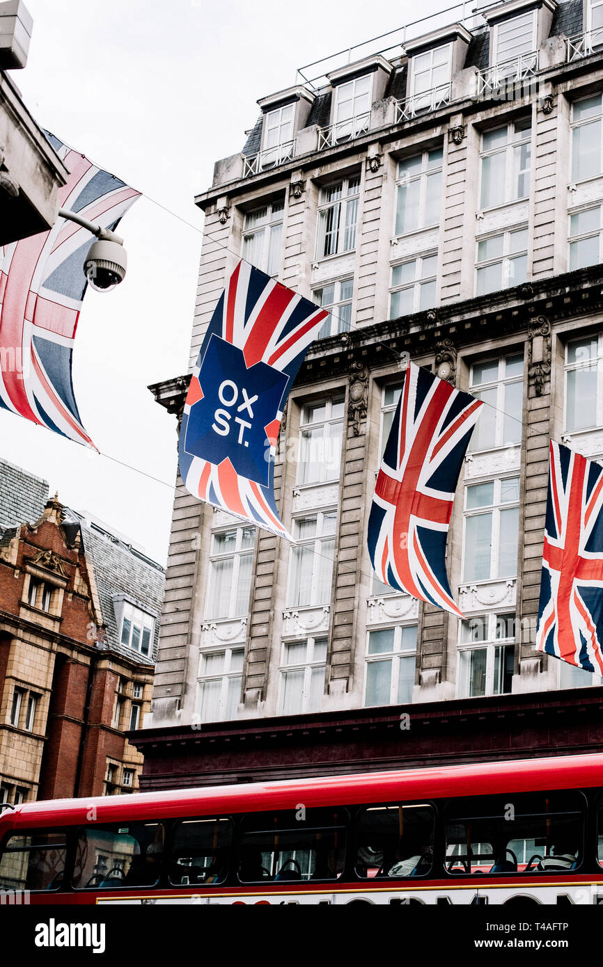 Union Jack flags hanging between two rows of buildings on Oxford Street ...