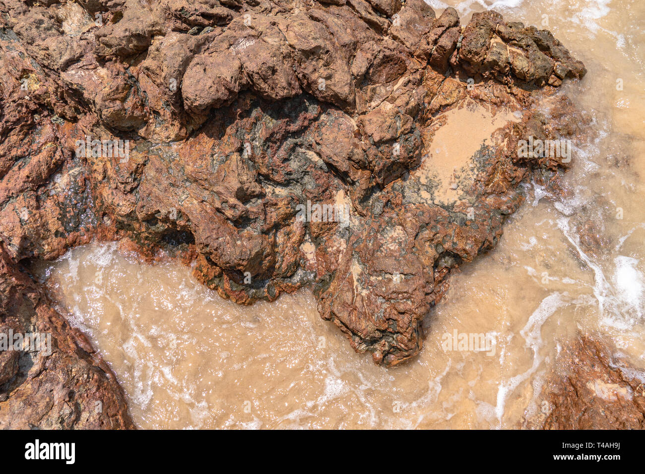top view of wave hit rock on the beach texture of rock when it wet and ...