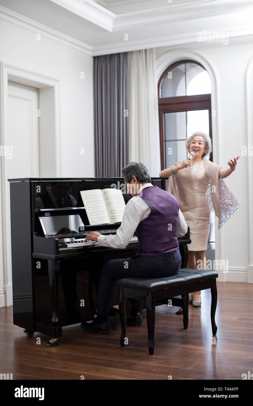 Noble senior couple singing and playing the piano together Stock Photo ...