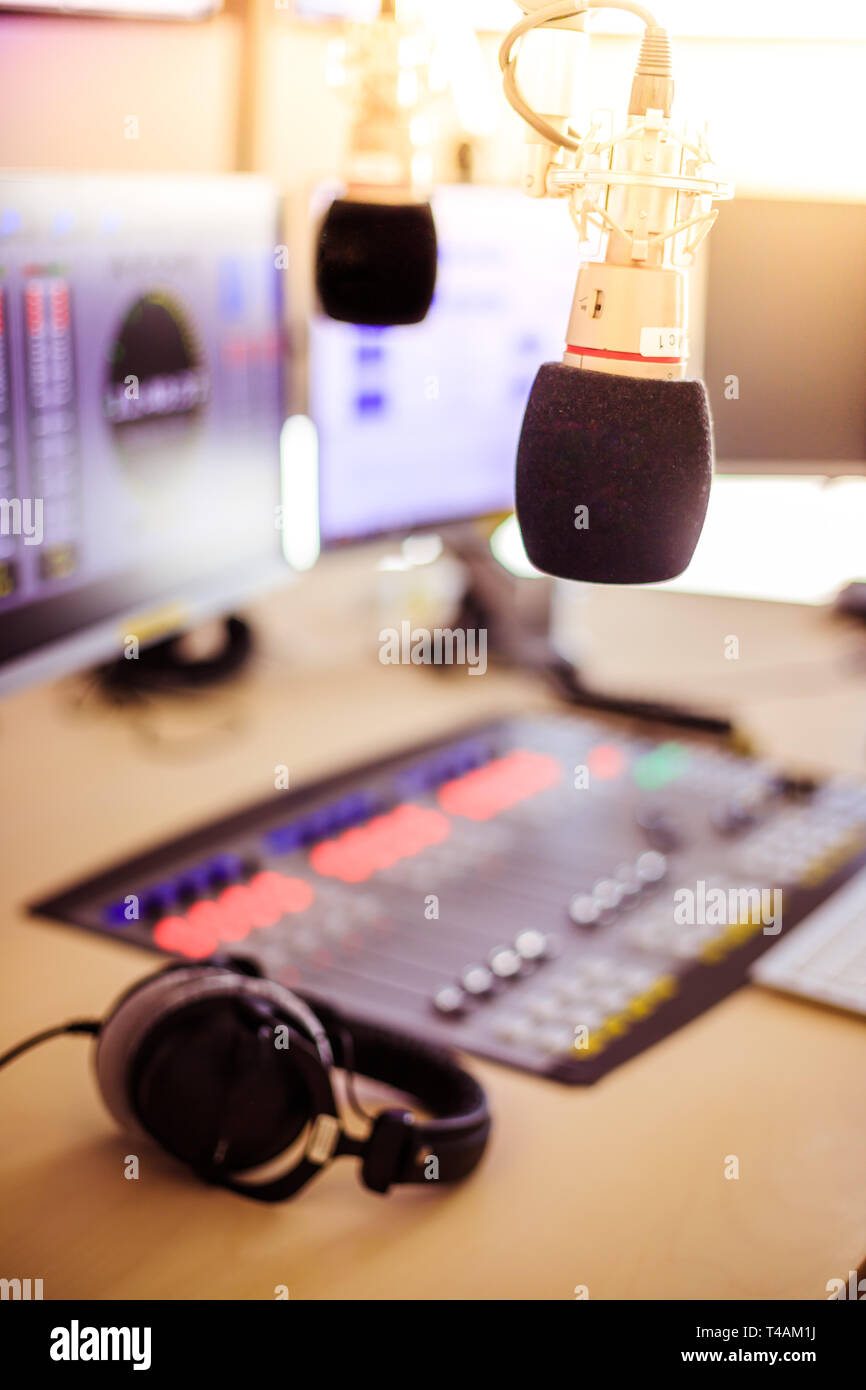 Studio microphone in a broadcasting radio studio, mixer and computer in ...