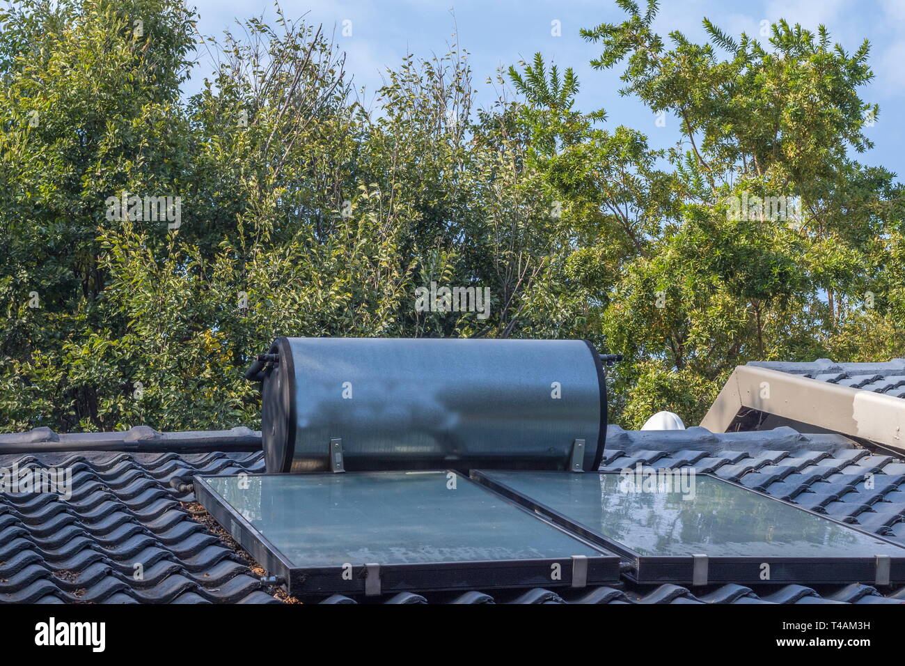 A solar geyser isolated on the roof of an urban home image with copy ...